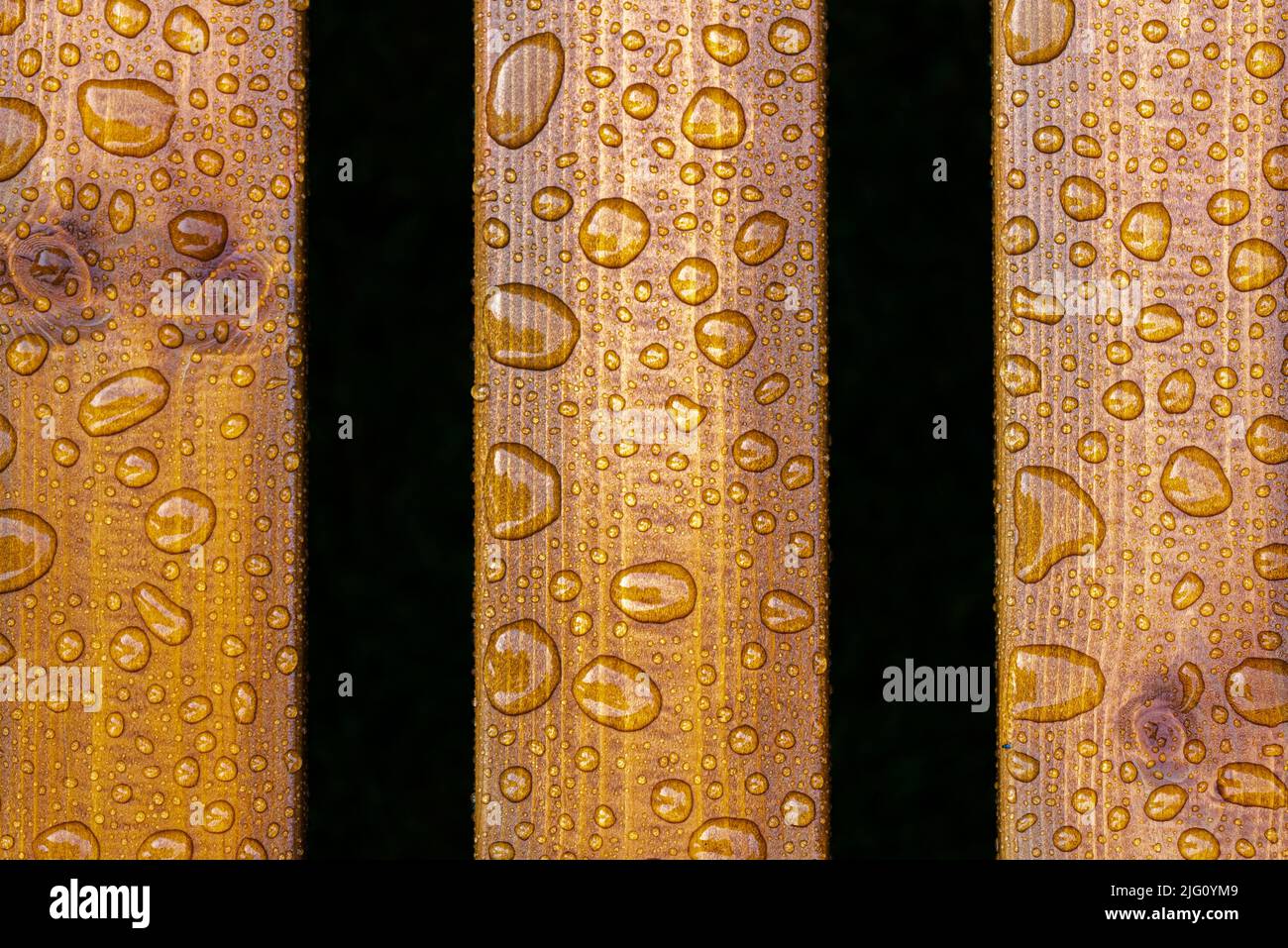 horizontal background of lacquered burnt wood texture with shiny water ...