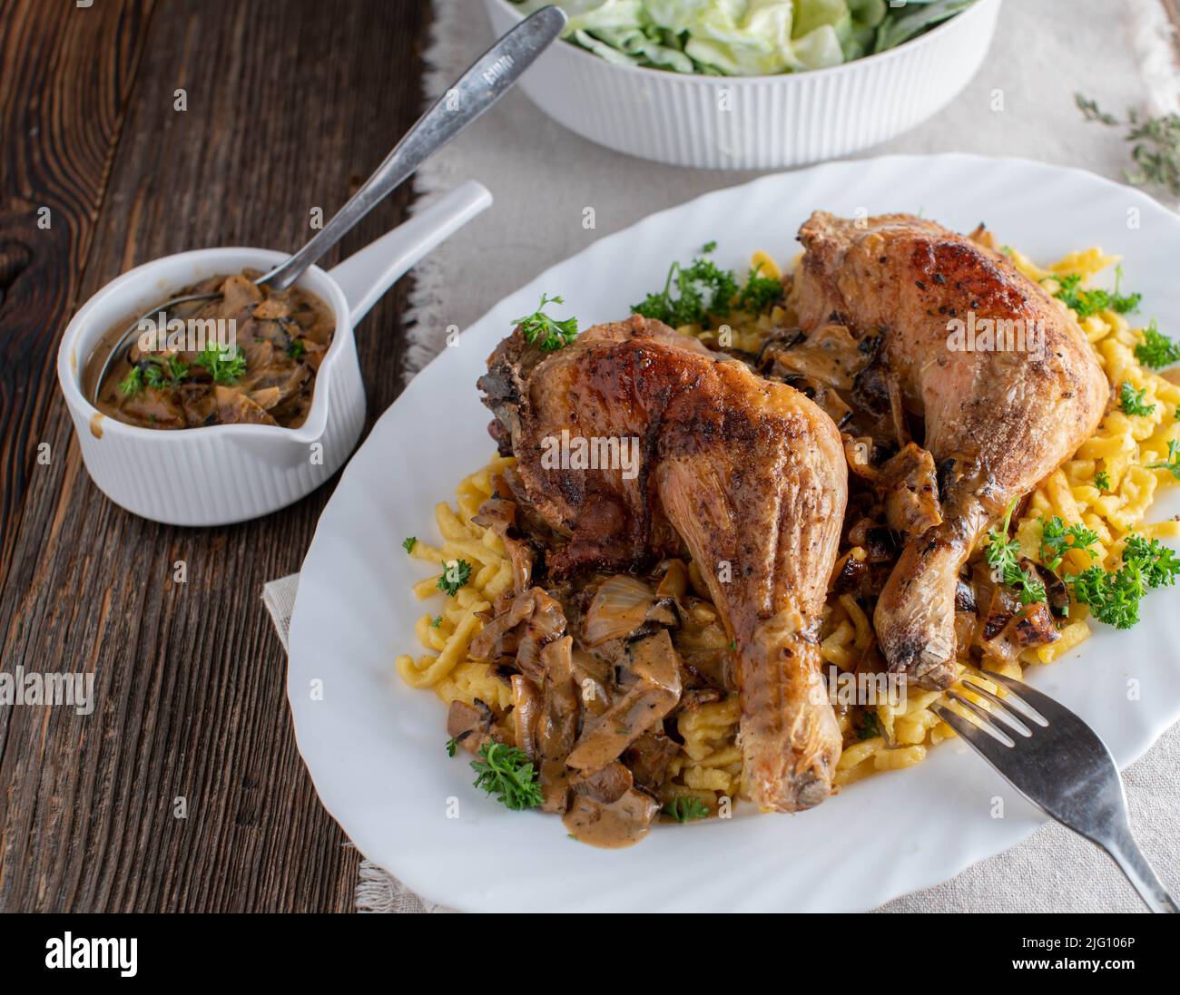 Roasted chicken legs with creamy onions sauce and german spaetzle ...