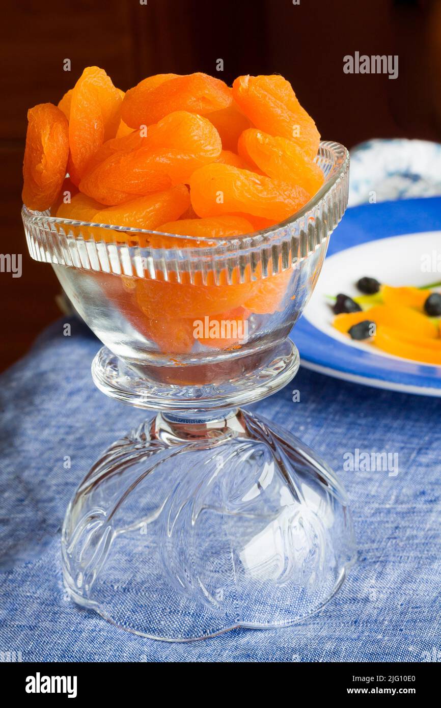 Selective focus on bowl of dried turkish apricots on dark black ...