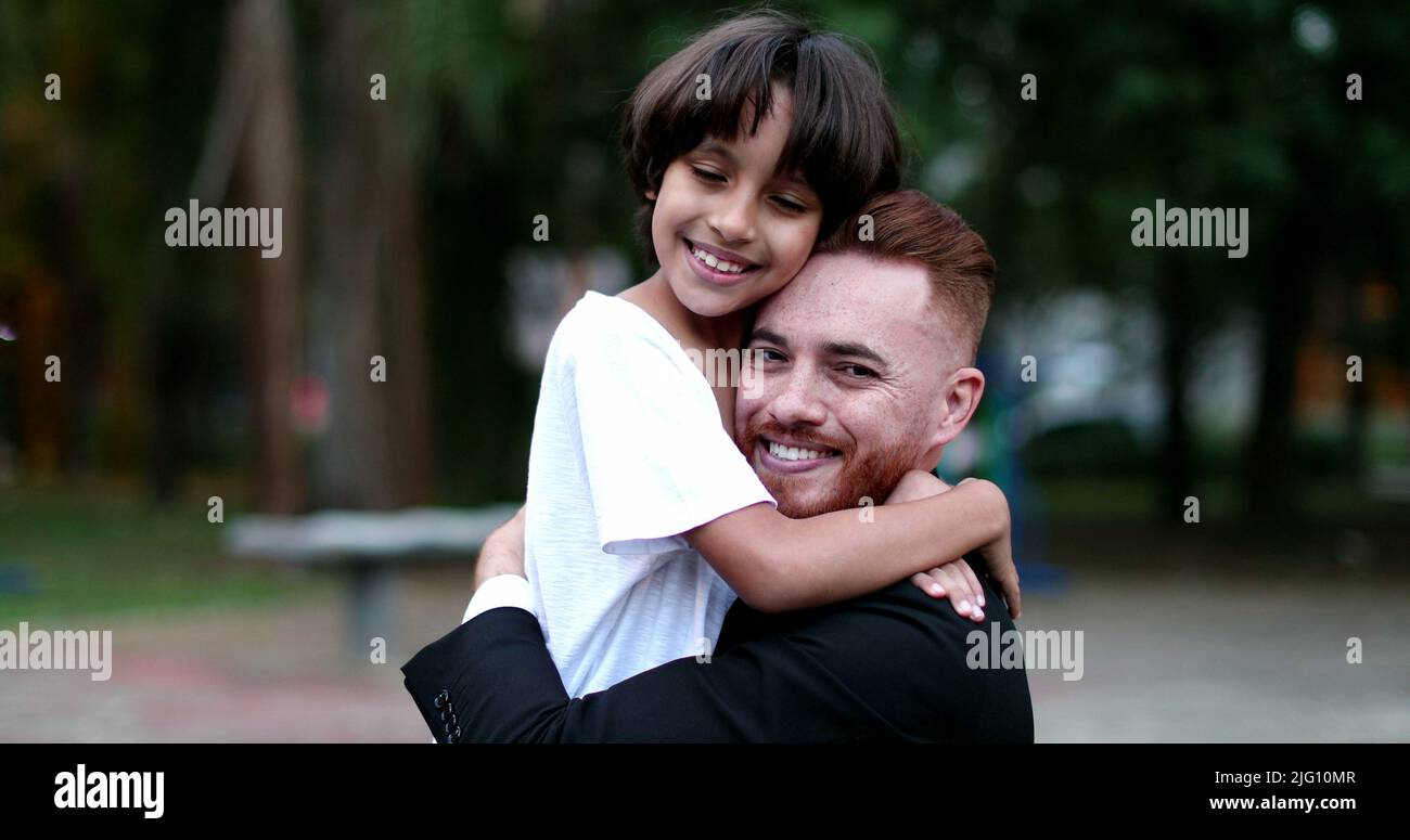 Parent and child hugging and embrace. Father and young boy ethnic ...