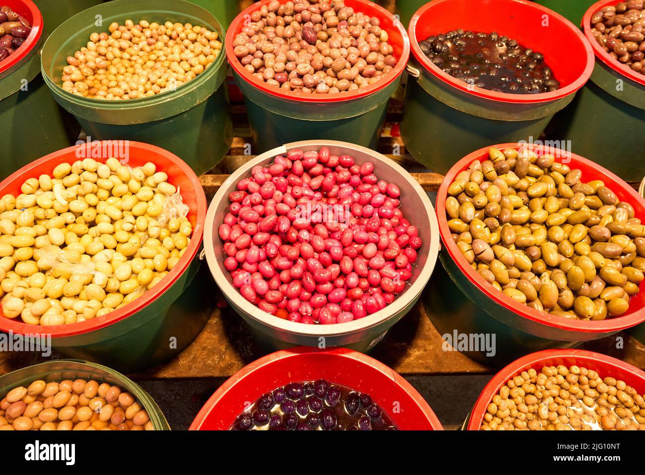 A pile of shiny Syrian green olives, full of oil. No kernels. Blurred ...