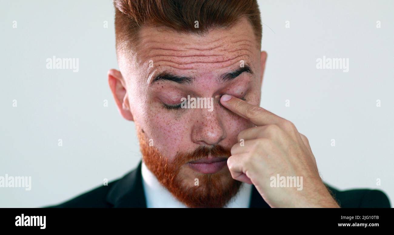 Pensive man touching face with hand. Thinking business person rubbing ...