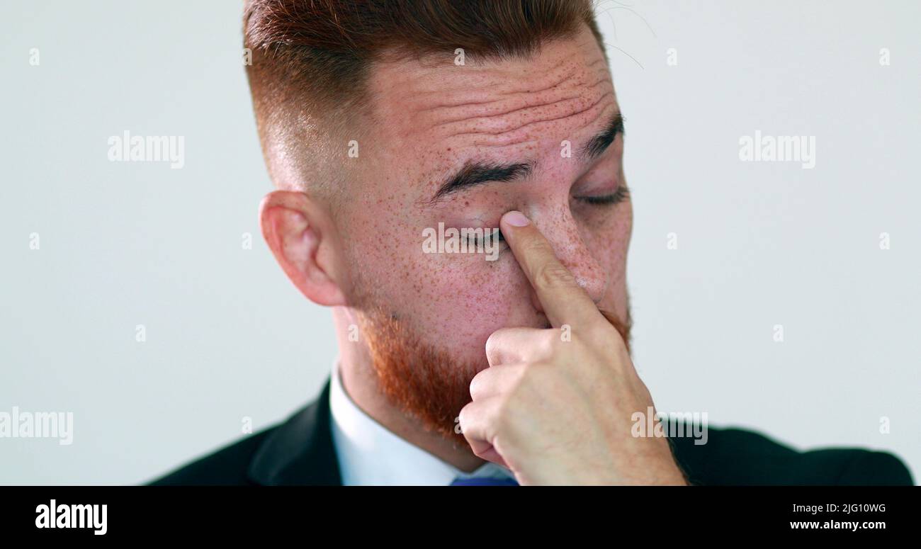 Pensive man touching face with hand. Thinking business person rubbing ...