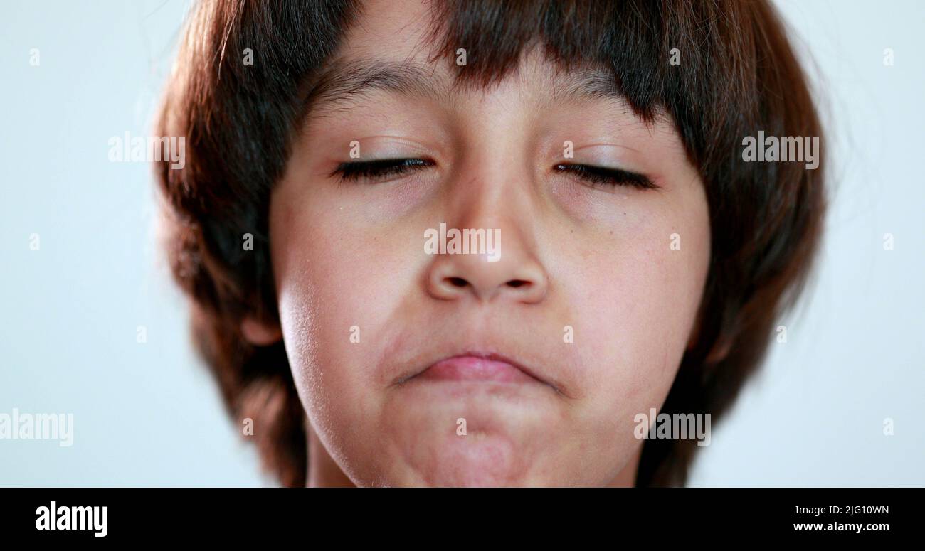 Pensive mixed race child thinking about solution. Ethnically diverse ...