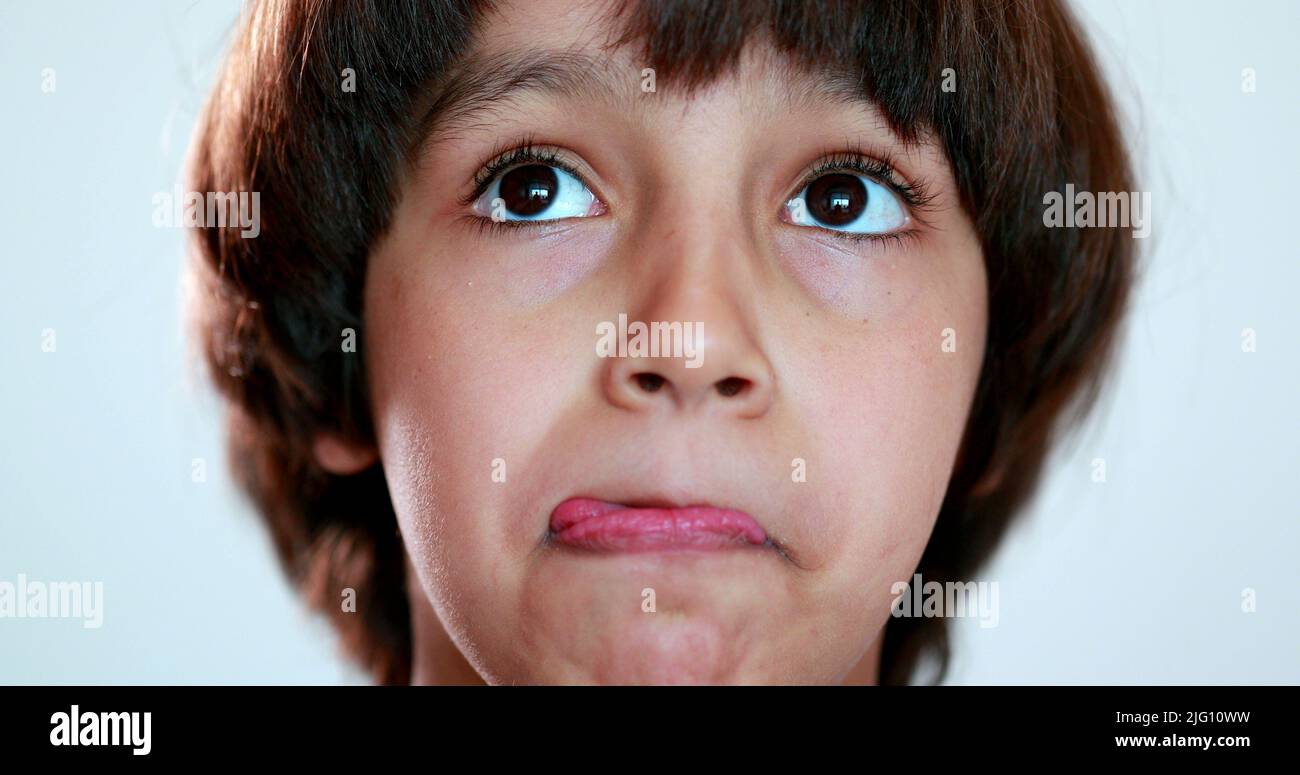 Pensive mixed race child thinking about solution. Ethnically diverse ...