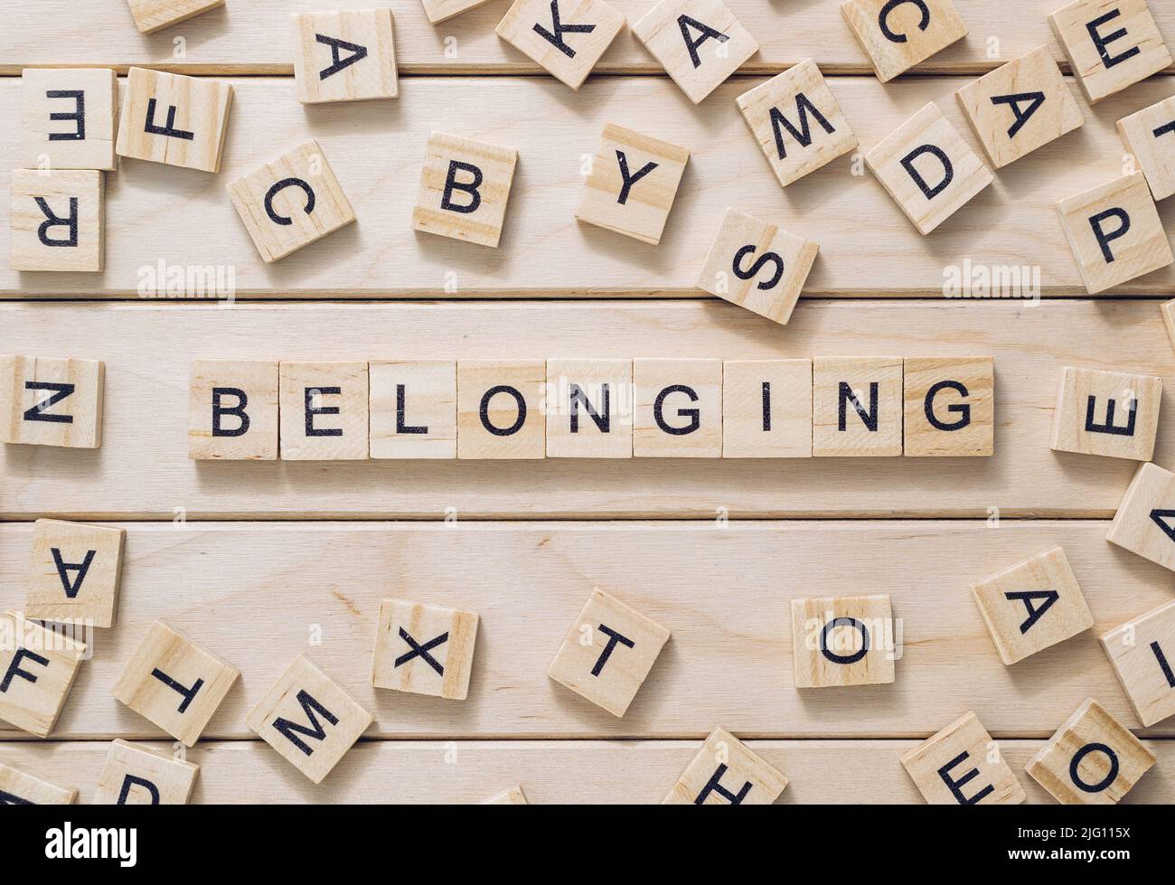 Word Belonging made with letter blocks on wooden background Stock Photo ...
