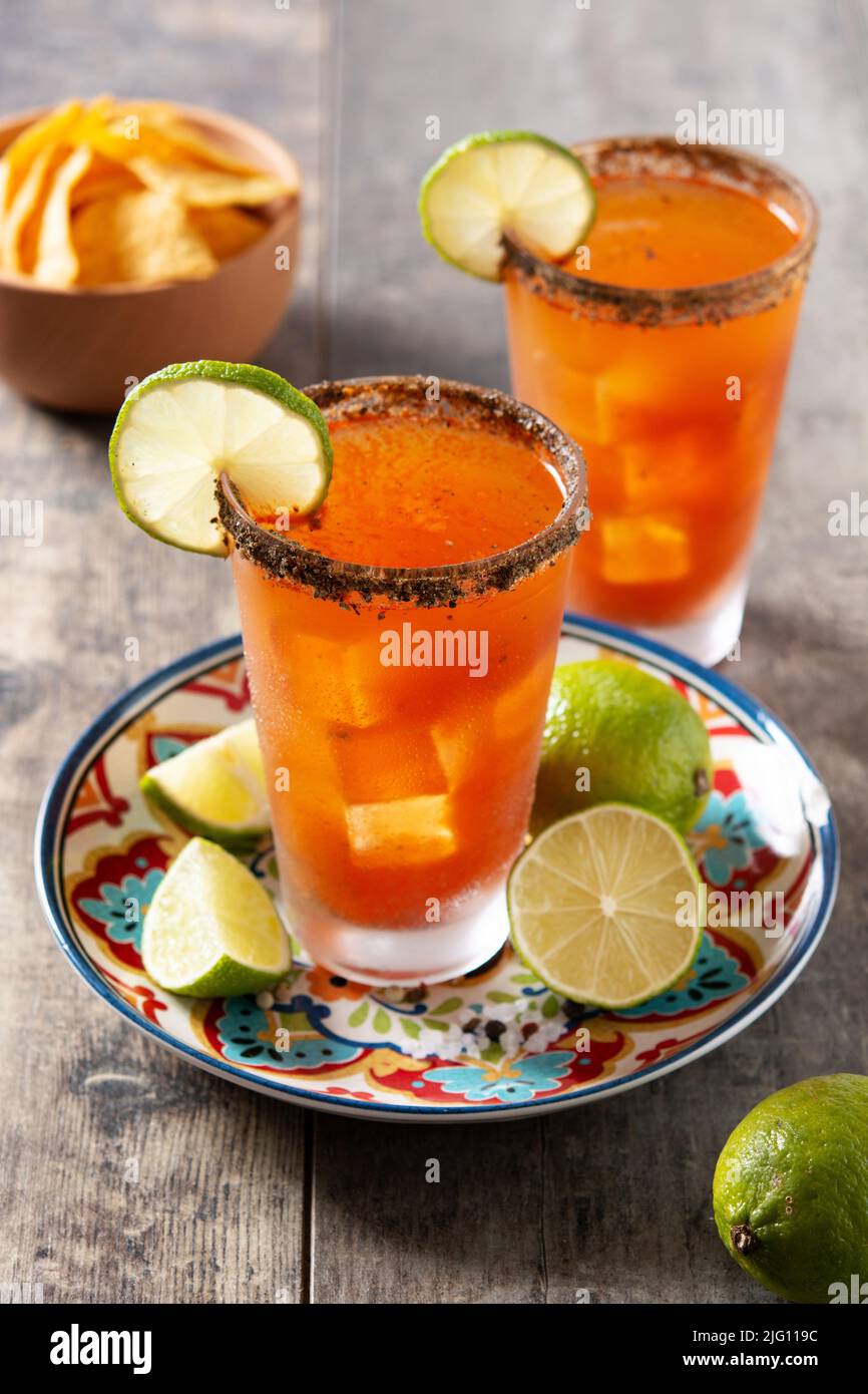 Homemade michelada cocktail with beer, lime juice,hot sauce,salted rim ...