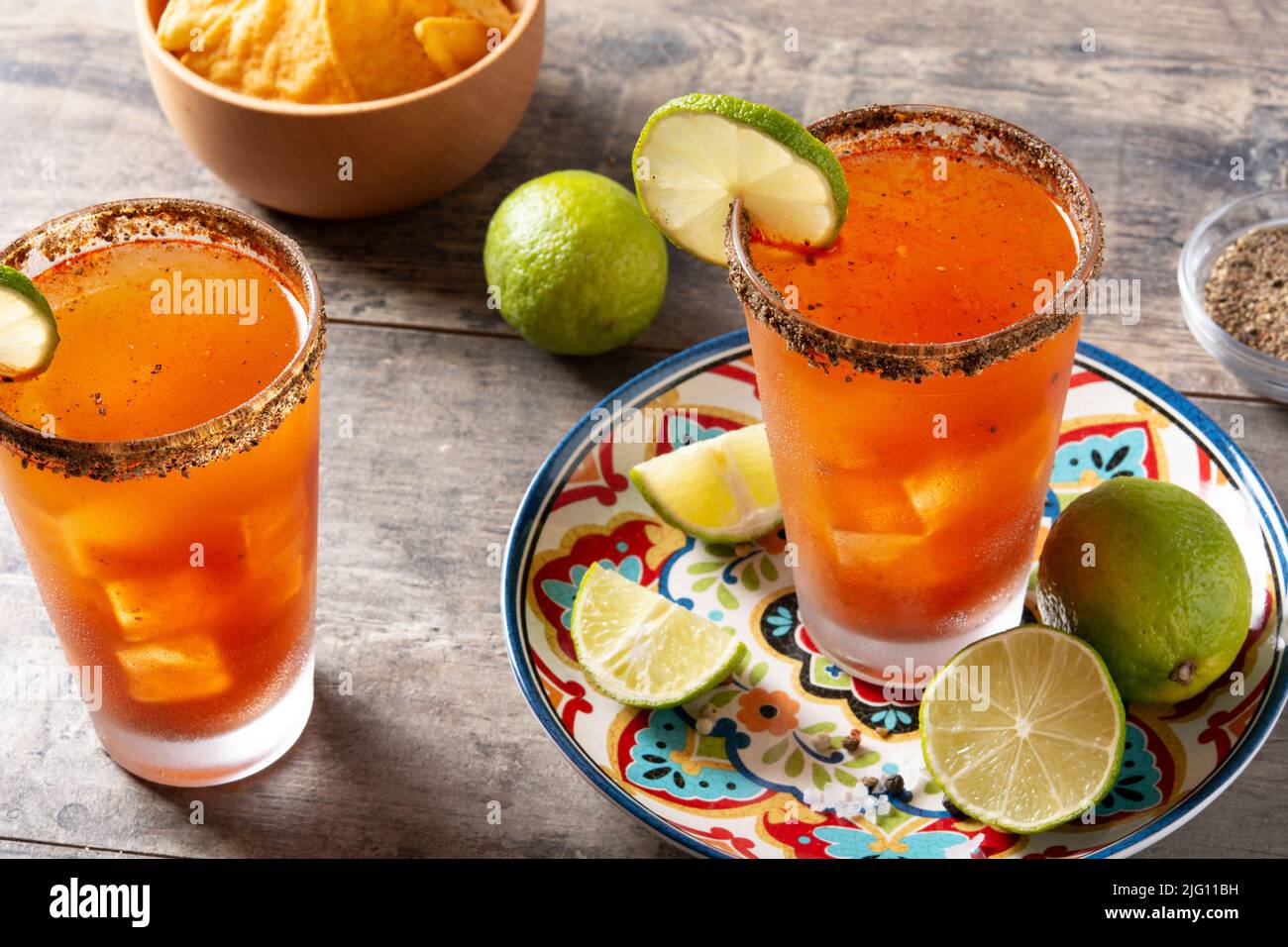 Homemade michelada cocktail with beer, lime juice,hot sauce,salted rim ...
