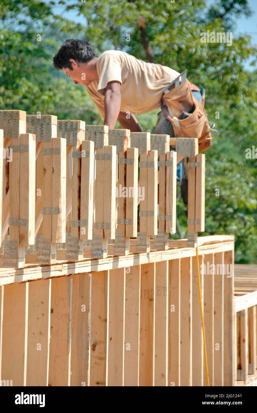 Latin work crew building wooden stick built house home cutting measure ...