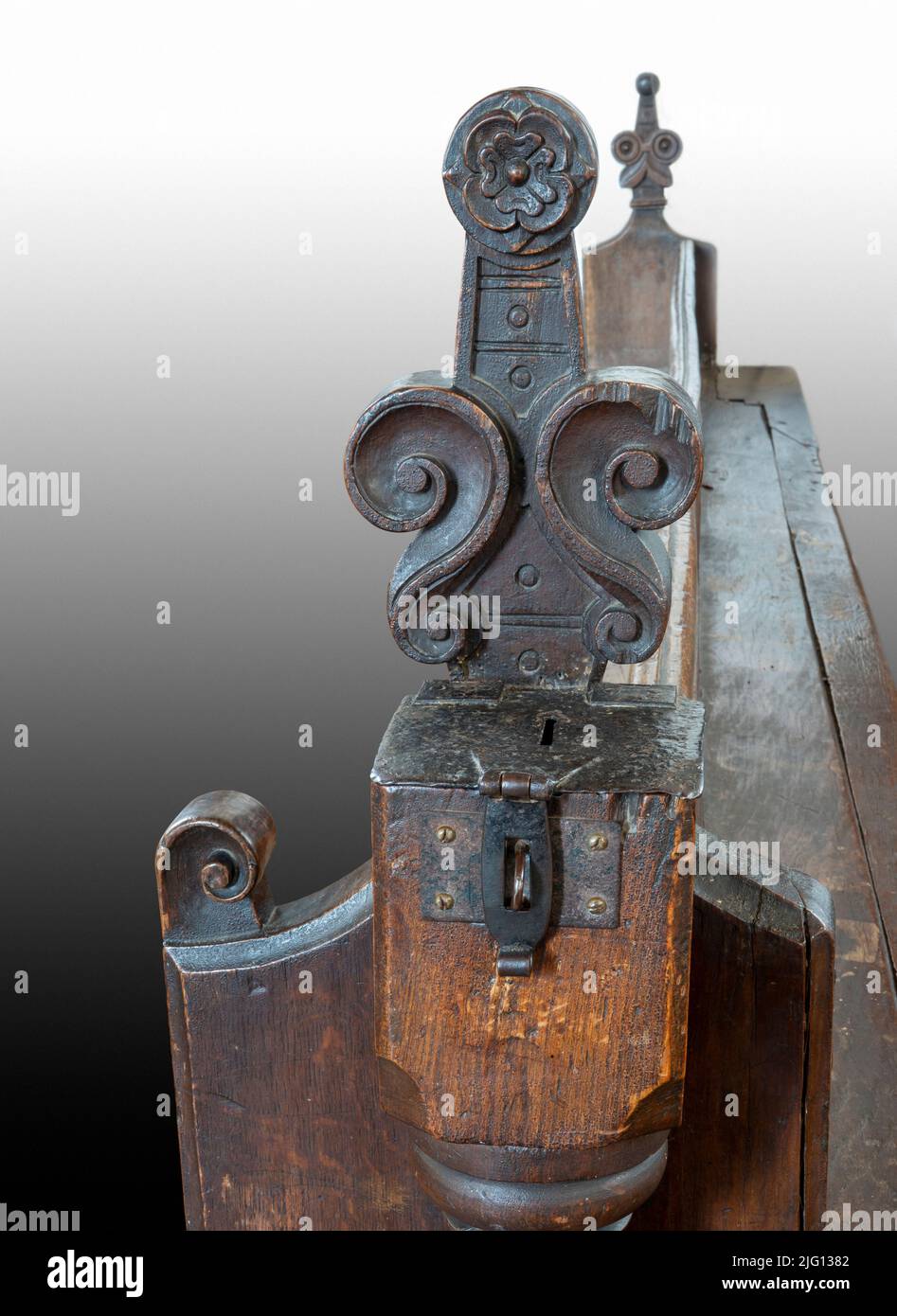 Carved wooden bench end forming a 'poor box' with metal hasp and ...