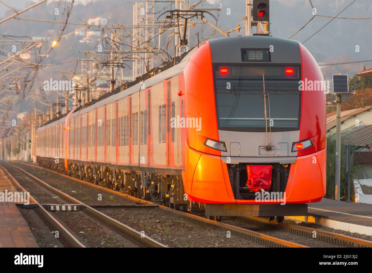 Express train leaves far from the station along the route Stock Photo ...