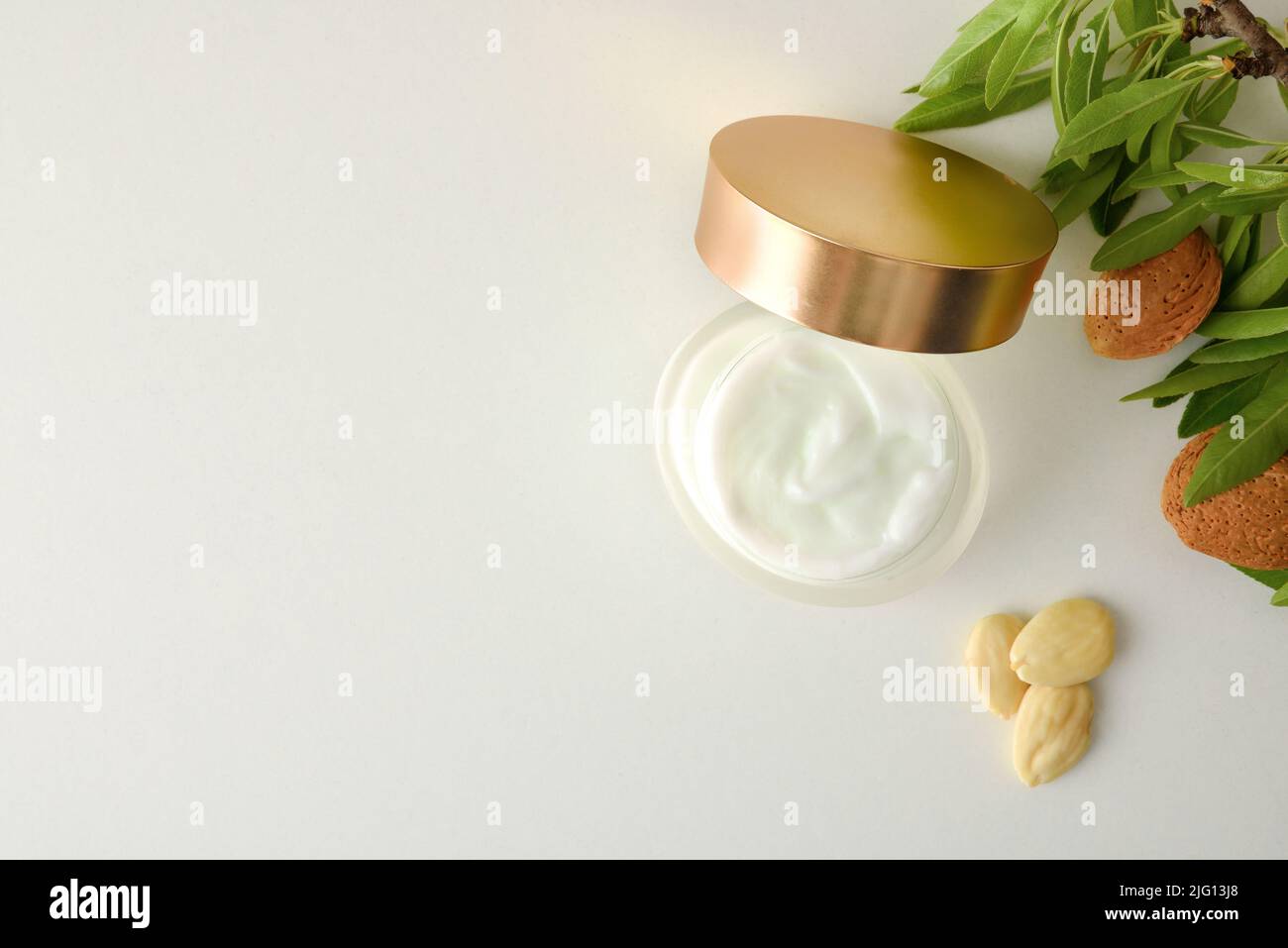 Detail of almond moisturizing cream skin care with fruits and leaves on ...