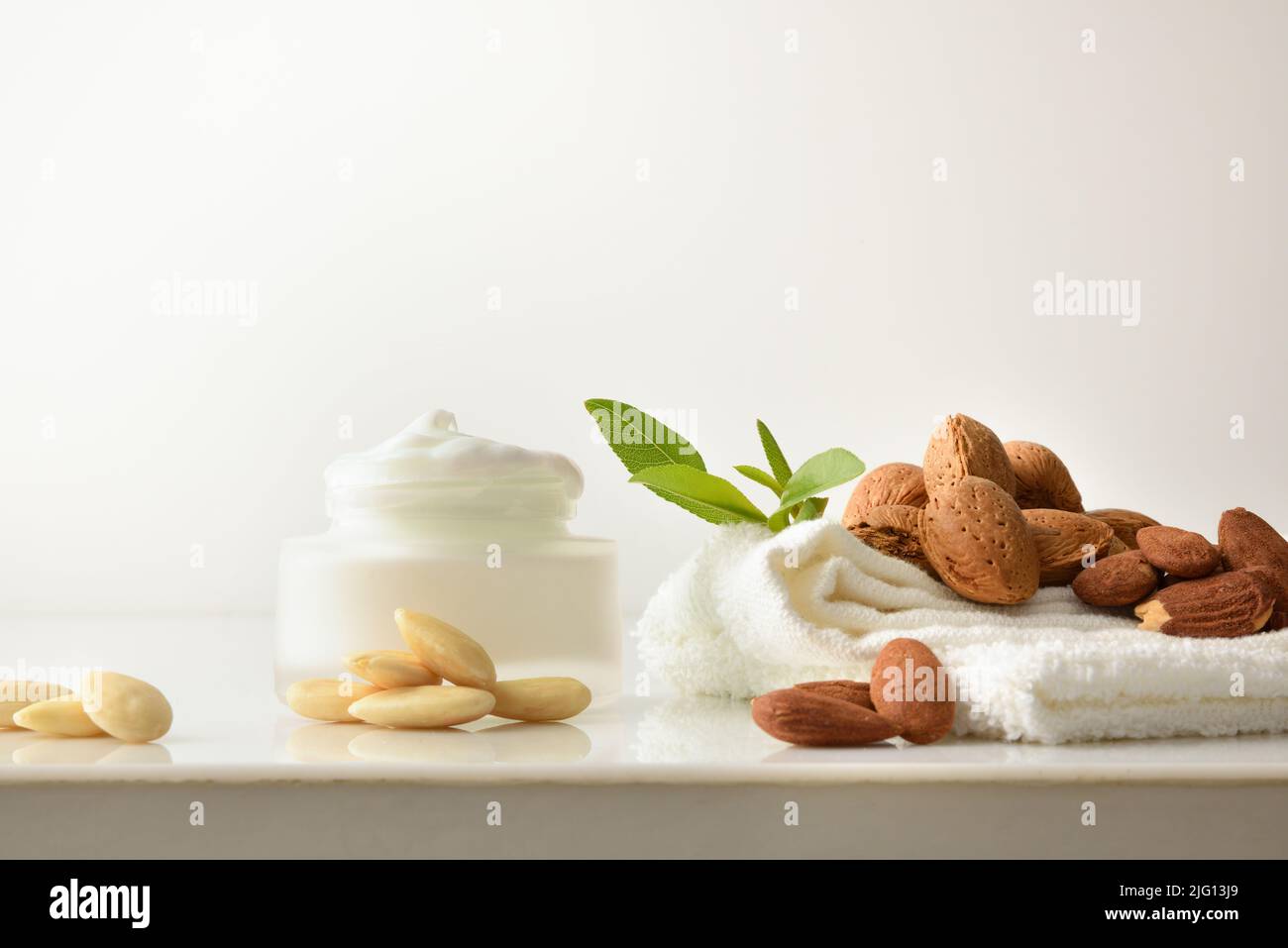 Almond moisturizing cream skin care with fruits towel and leaves on ...