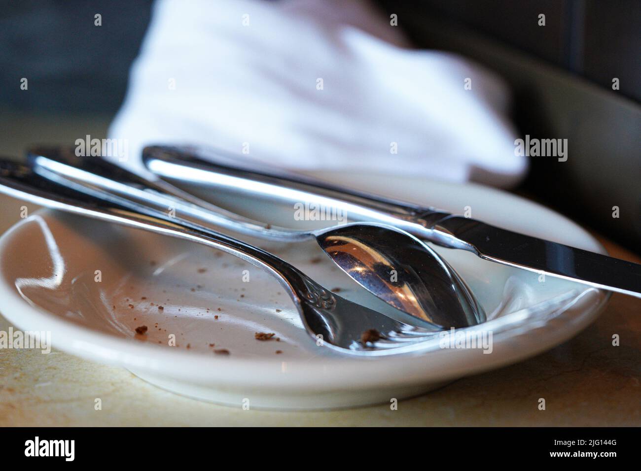 dirty Cutlery and charger plates at a restaurant table, silverware ...