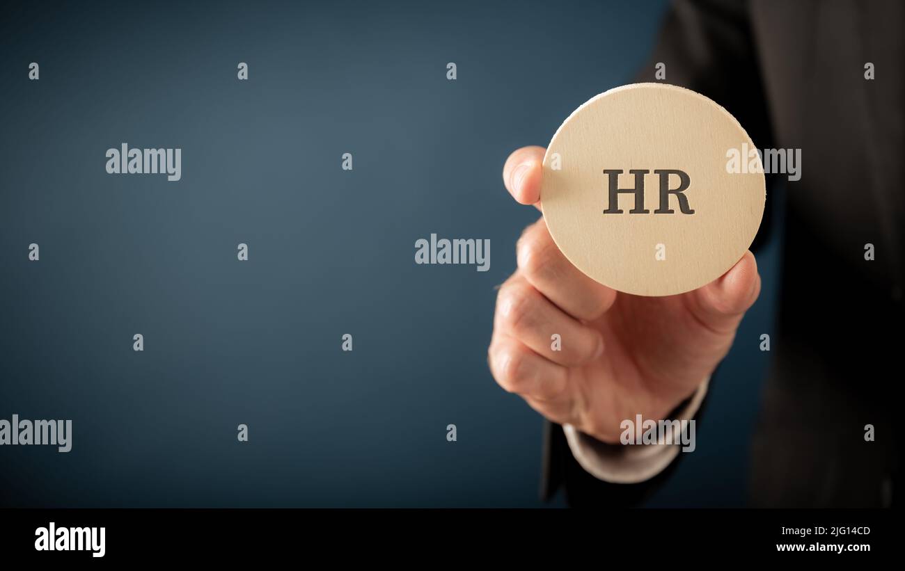 Closeup view of a businessman, an employer, holding a wooden cut circle ...