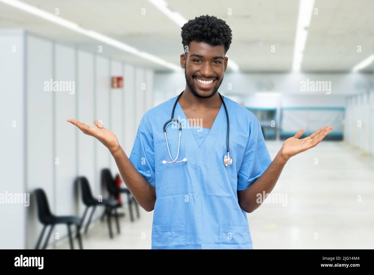 Friendly african american male nurse with beard at vaccination station ...