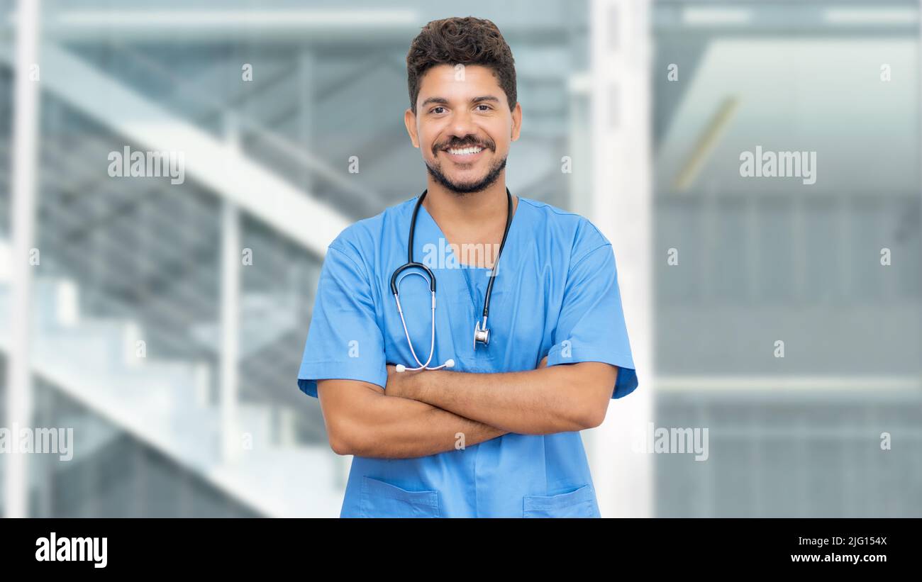 Laughing hispanic male nurse with beard at clinic Stock Photo - Alamy