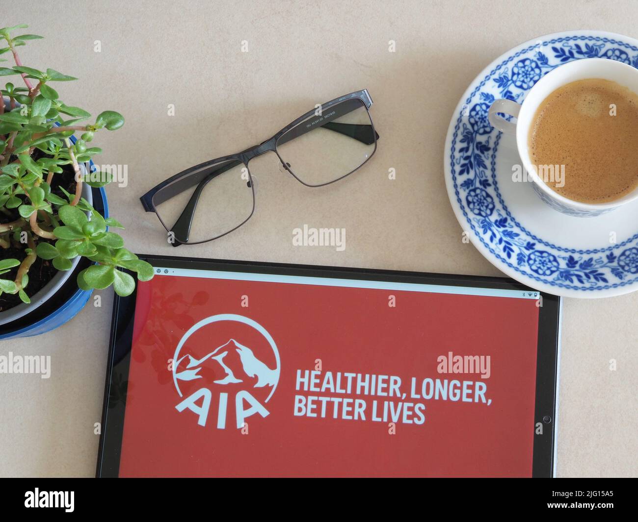 In this photo illustration an AIA Group logo seen displayed on a tablet ...