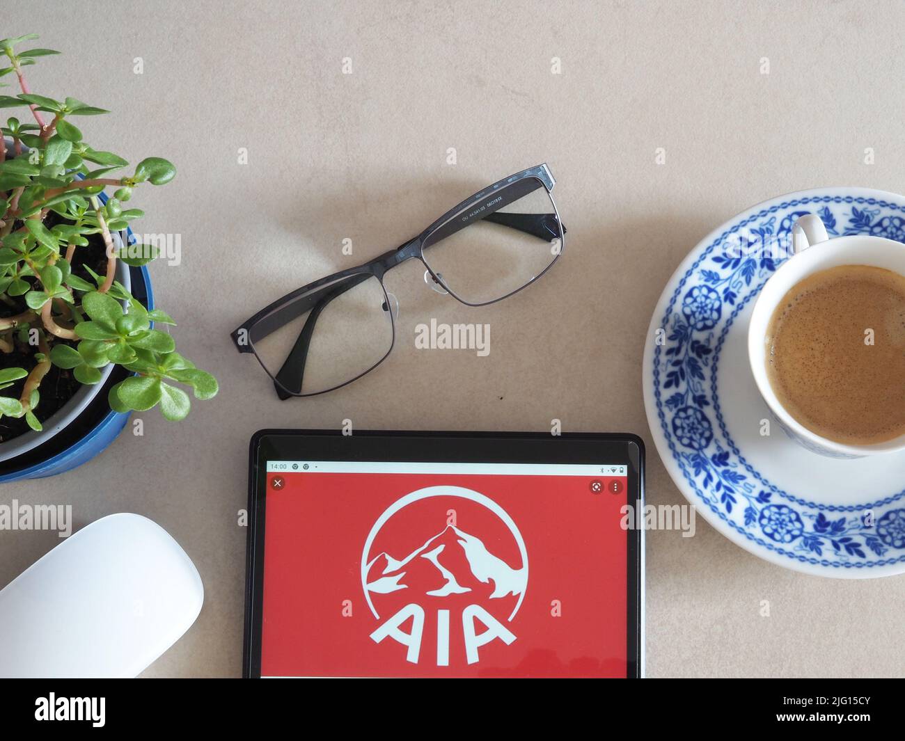 In this photo illustration an AIA Group logo seen displayed on a tablet ...