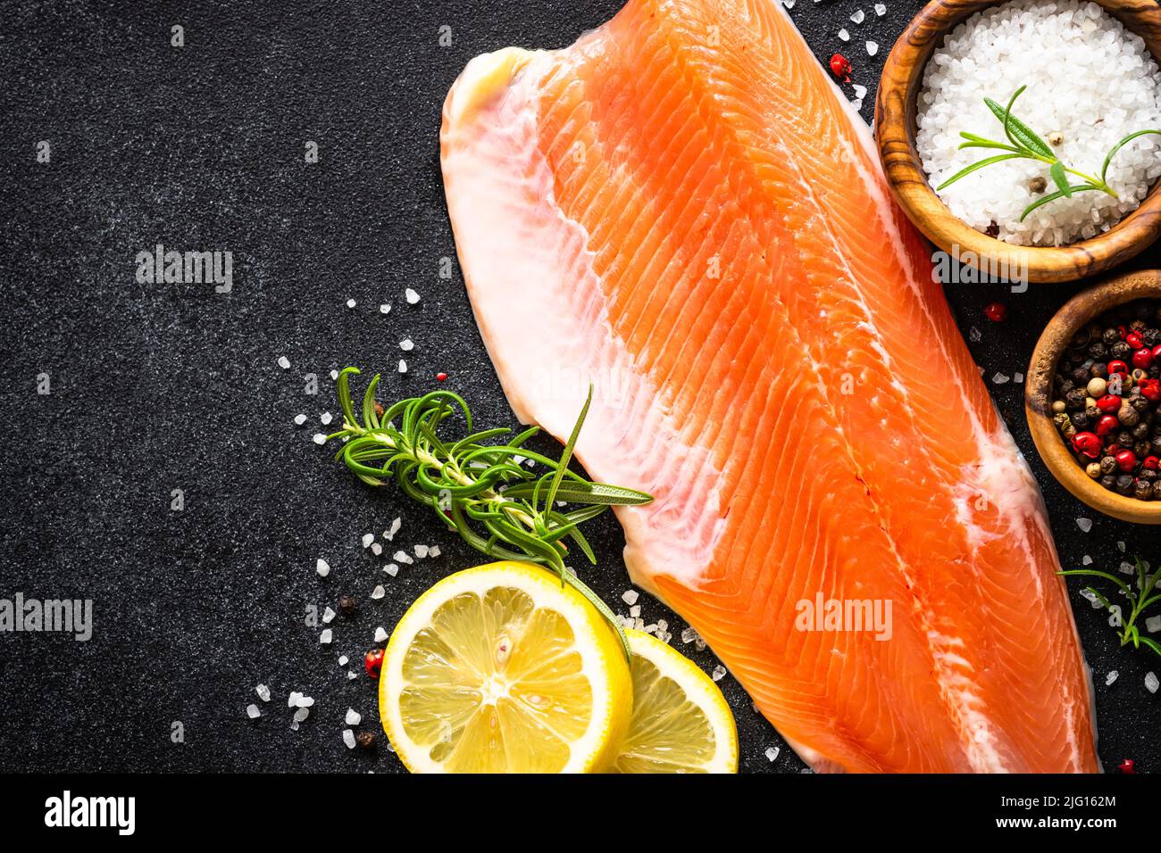 Fresh salmon fish at black top view Stock Photo - Alamy