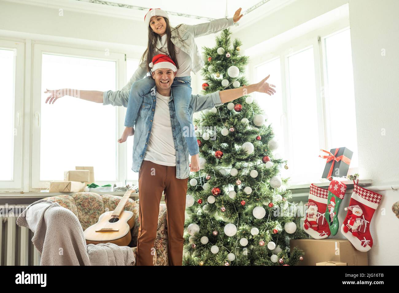 father and daughter near the Christmas tree Stock Photo - Alamy