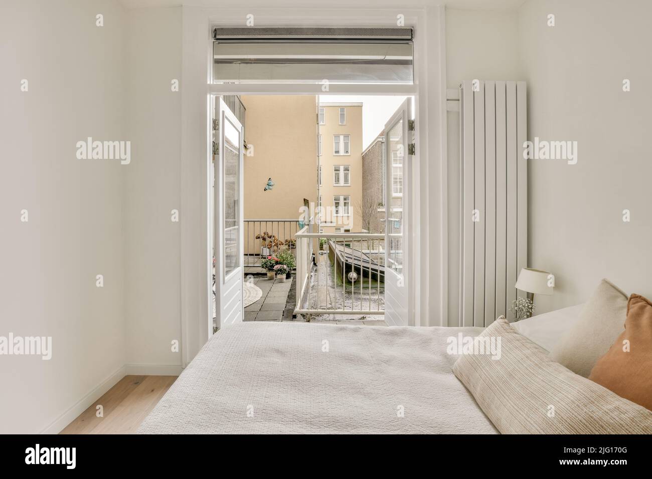 Home interior design of bedroom with bed and wooden wardrobe placed in ...