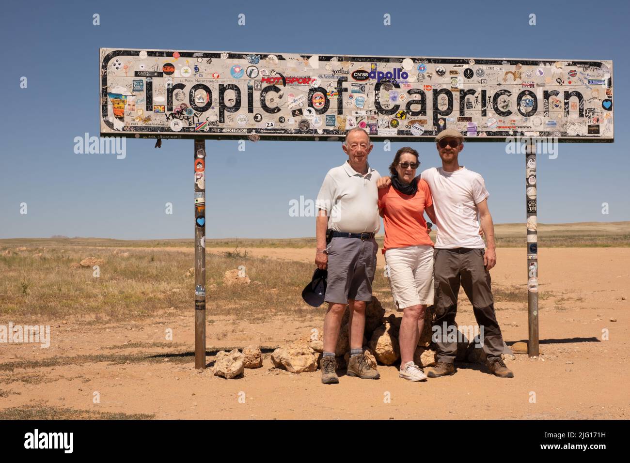A family by the sign marking the Tropic of Capricorn in Namibia Stock ...