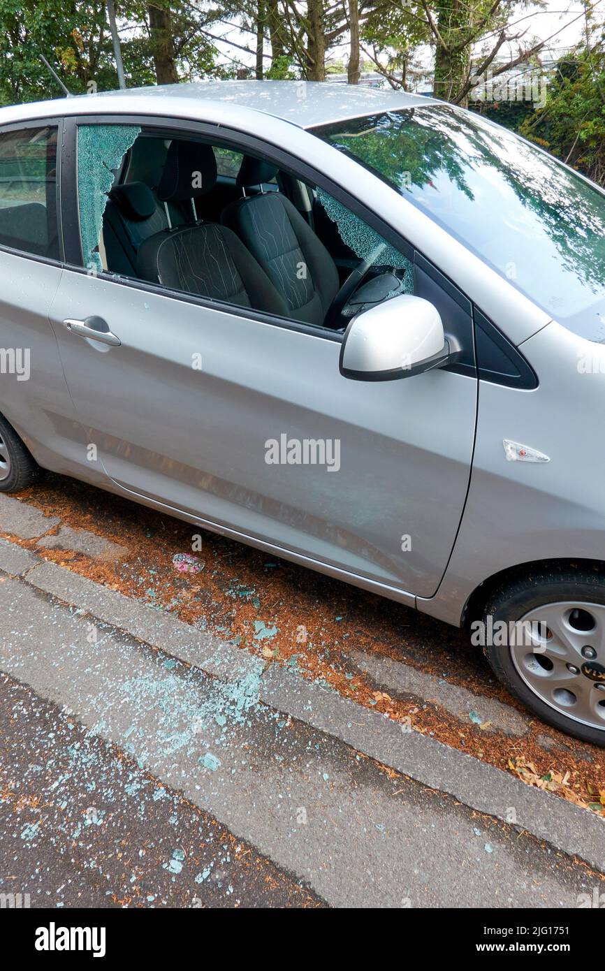 Car broken into by smashing the drivers side door window Stock Photo ...