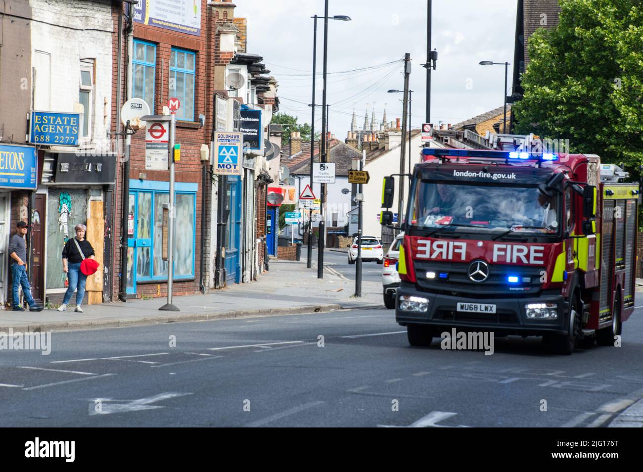 London Fire Brigade fire engine with blue lights in South London high ...