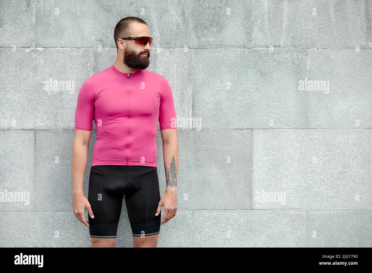 Portrait of sportsman in pink sportwear resting after an workout while ...