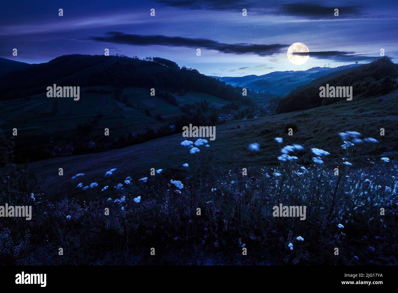 mountainous countryside landscape at night. rural fields on the hills ...