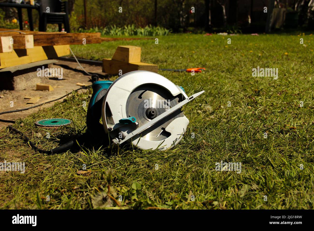 Circular saw with a round disk plugged into an electricity source ...