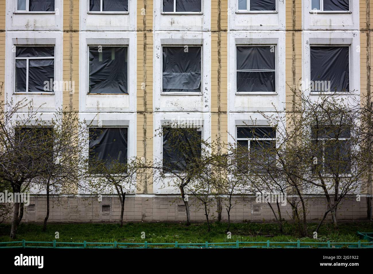 KYIV, UKRAINE - APR 21, 2022: All the windows of the high school on ...