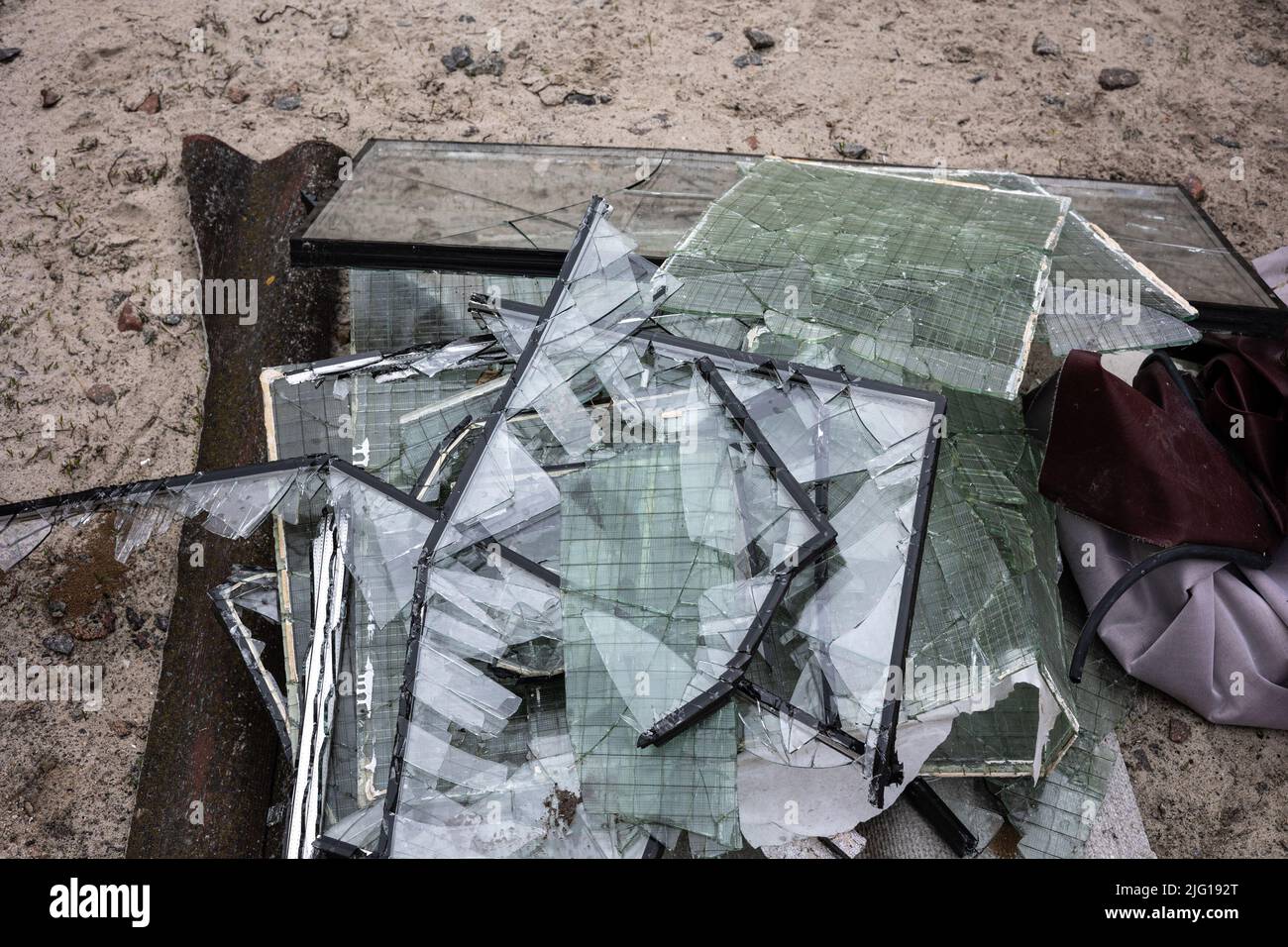 Piles of broken glass from windows from the apartment buildings were ...