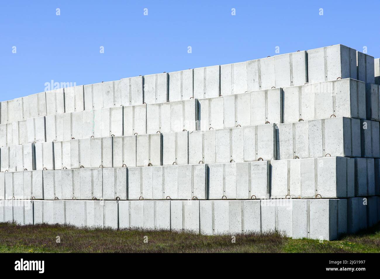 Stack of many large white concrete cube shaped blocks in the factory ...