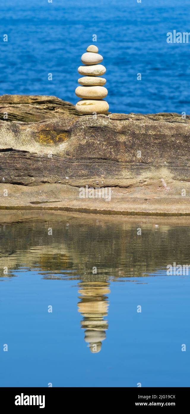 Stacked stone tower on the beach by the sea Stock Photo - Alamy