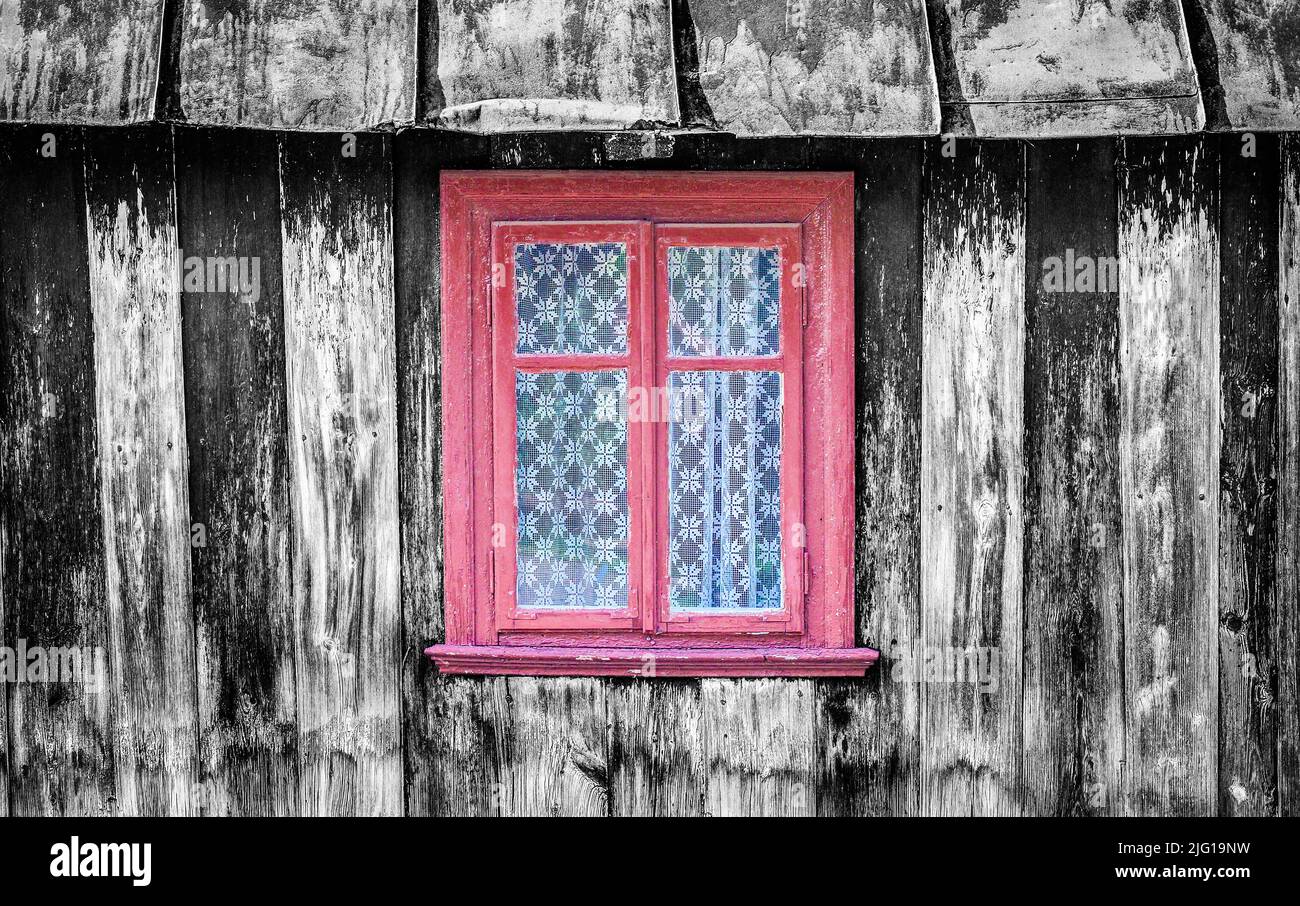 Window in brown painted frame of very old wooden house, monochrome ...