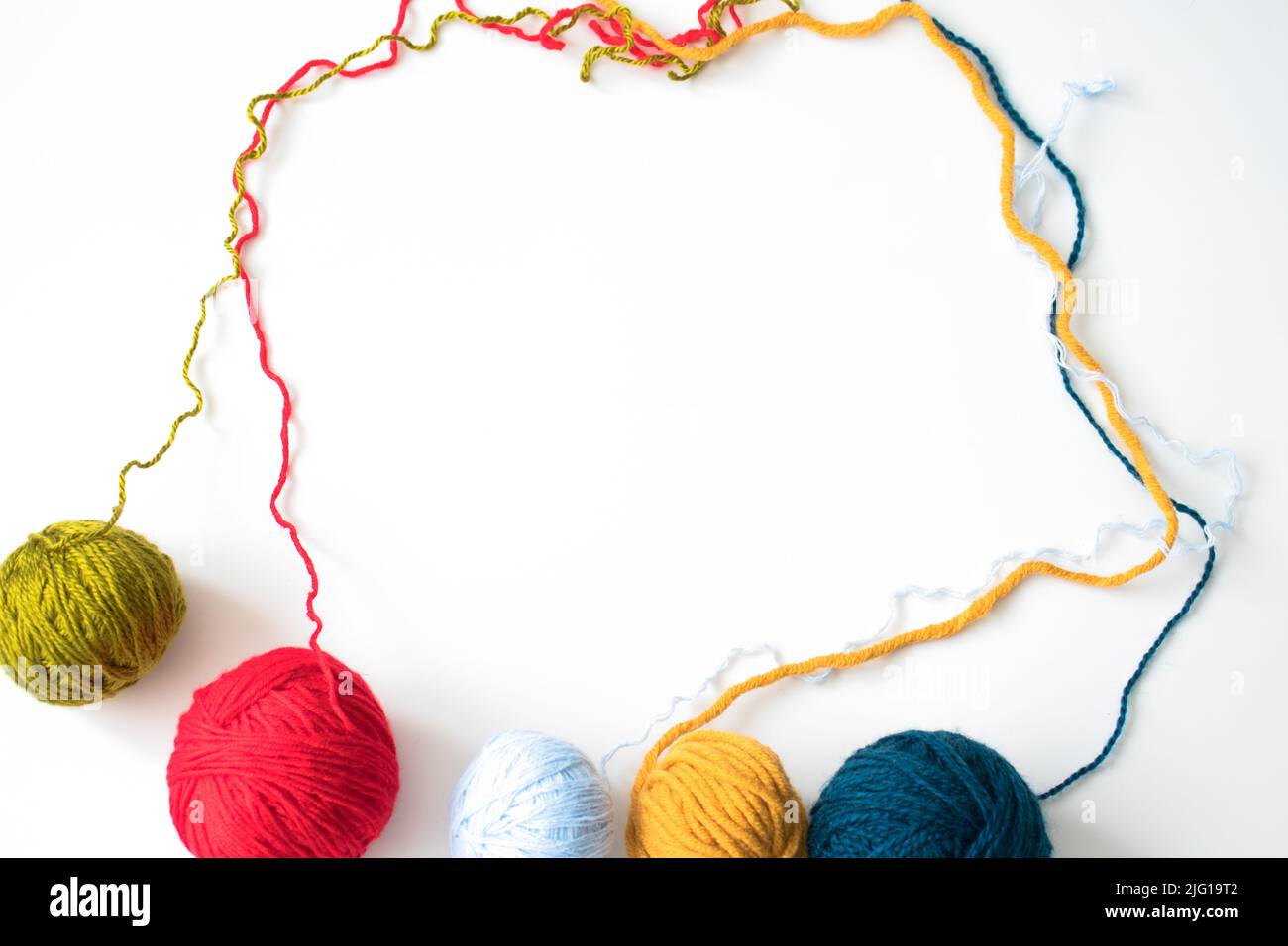 Craft idea concept, tangled colored wools isolated on white background ...