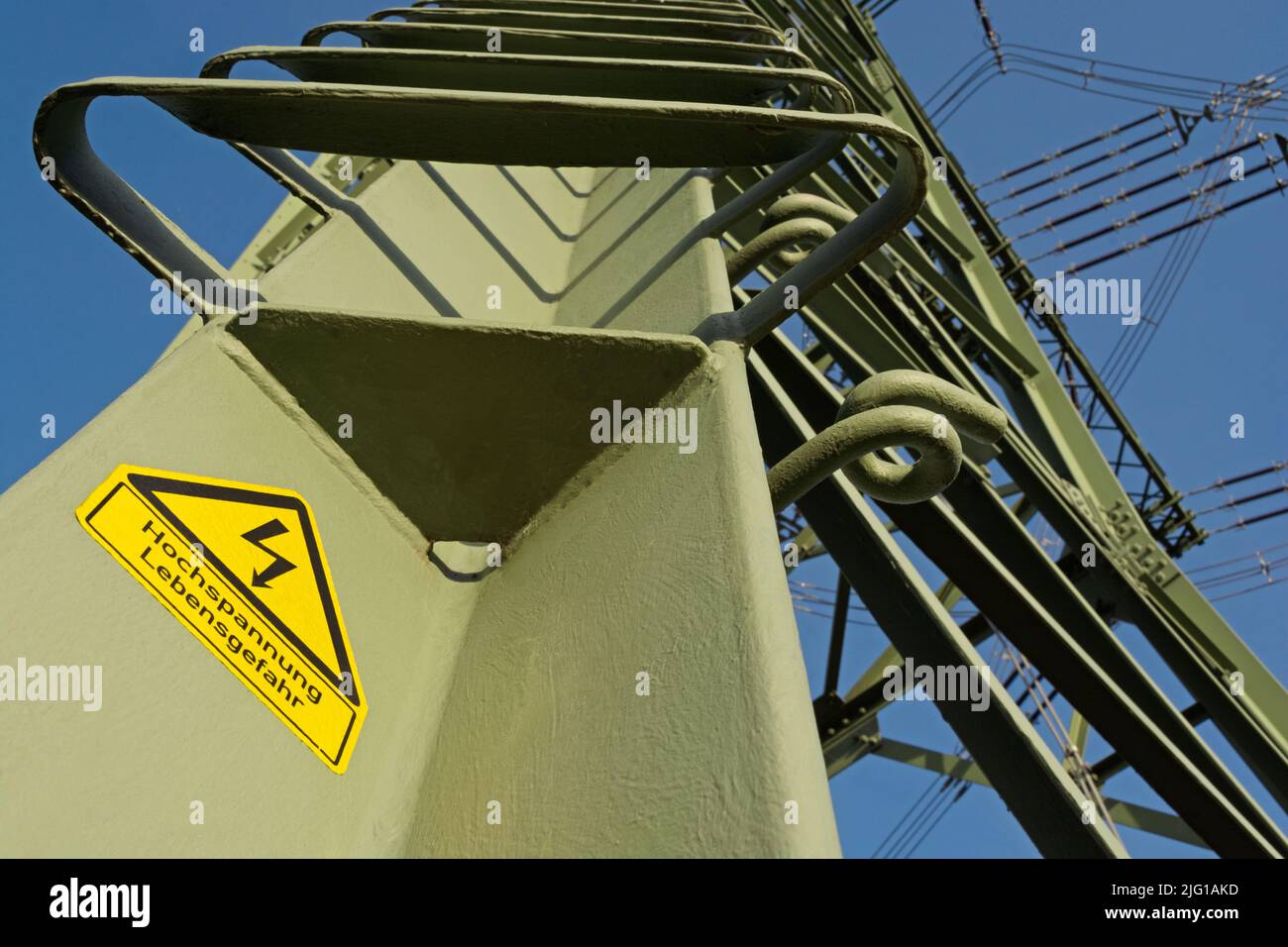 Electricity pylon with warning notice (in German Stock Photo - Alamy