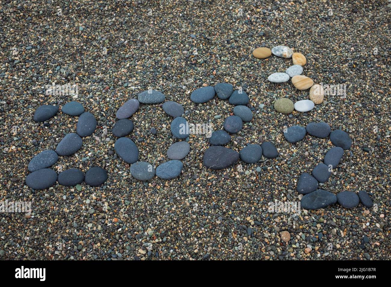 Flipping of 2022 to 2023 made from stones on beach. preparation new ...