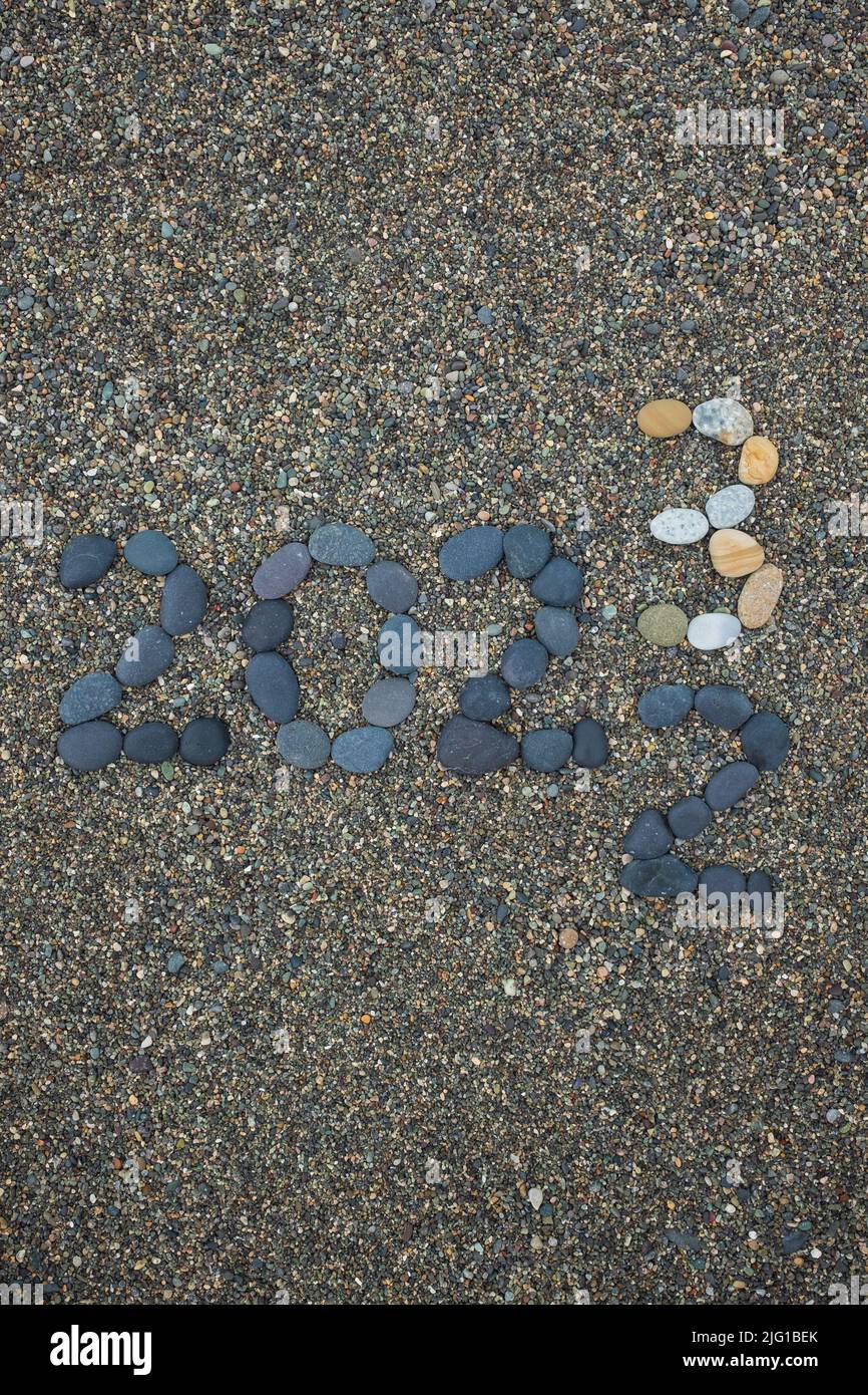 Flipping of 2022 to 2023 made from stones on beach. preparation new ...