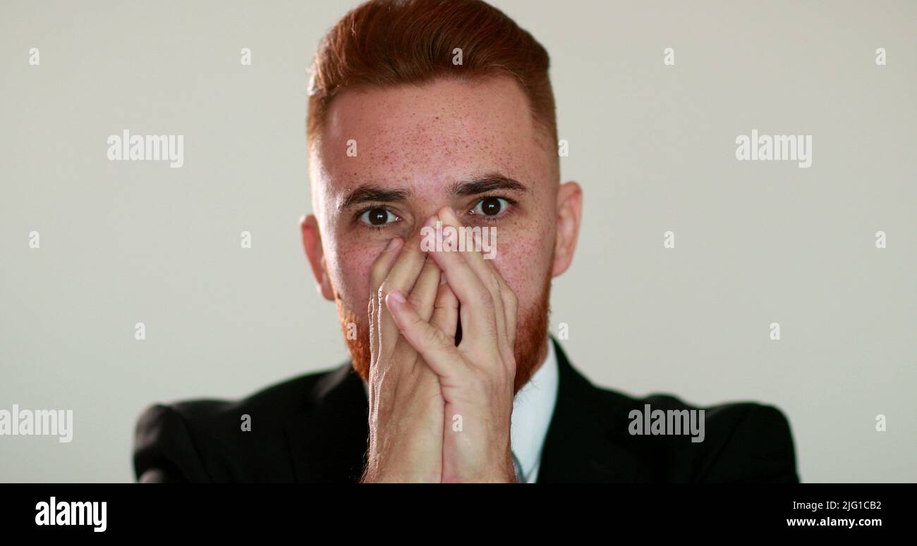 Perplexed man reaction with unbelief emotion. Person hiding face with ...