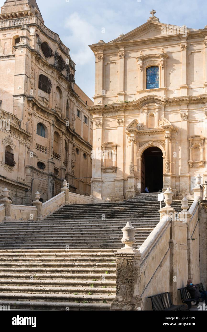 Noto,Italy-May 7, 2022:people stroll in Noto in front off the Church of ...