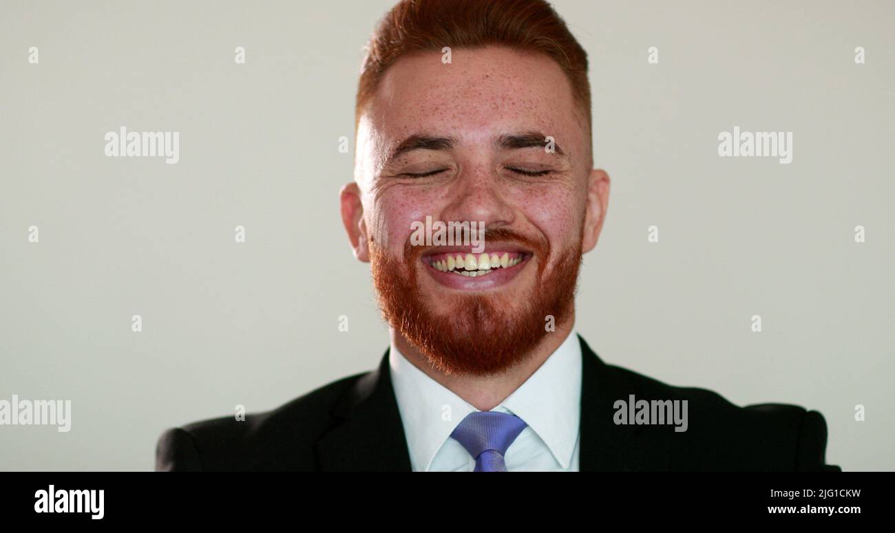 Spontaneous real life smile and laugh. Handsome redhead man smiling and ...