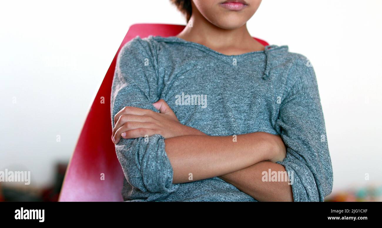 Upset child crossing arms feeling offended, angry kid, african descent ...