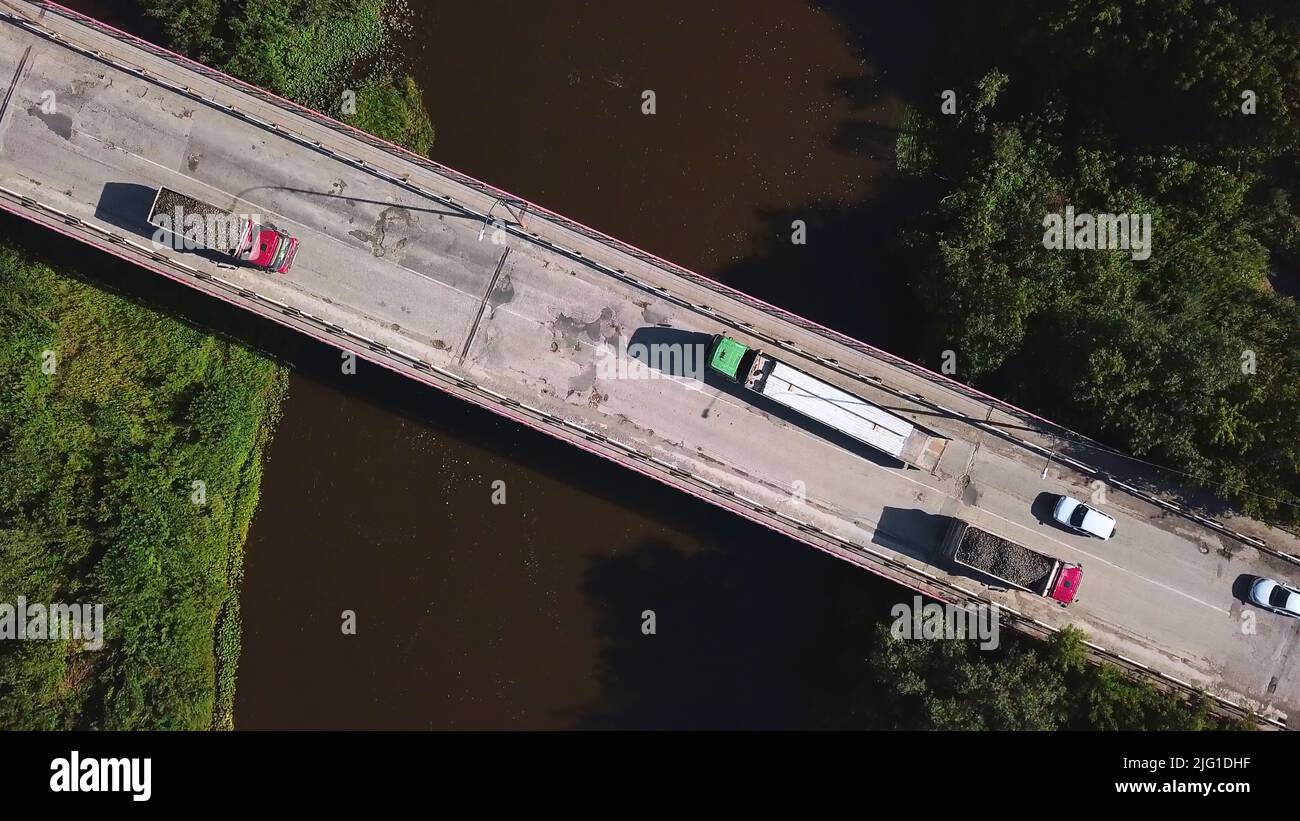 Top view of passing vehicles on bridge over river. Clip. Trucks and ...