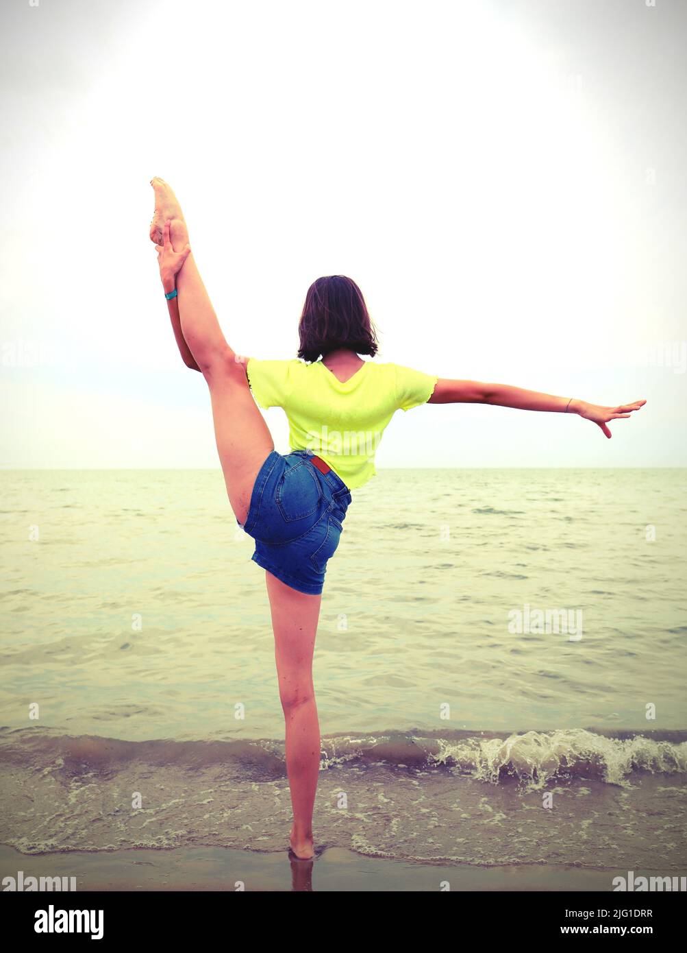 young slender girl staying in balance with old toned effect Stock Photo ...