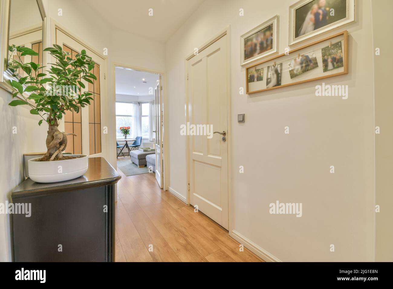 Interior of narrow corridor with many doors and classic painting on ...
