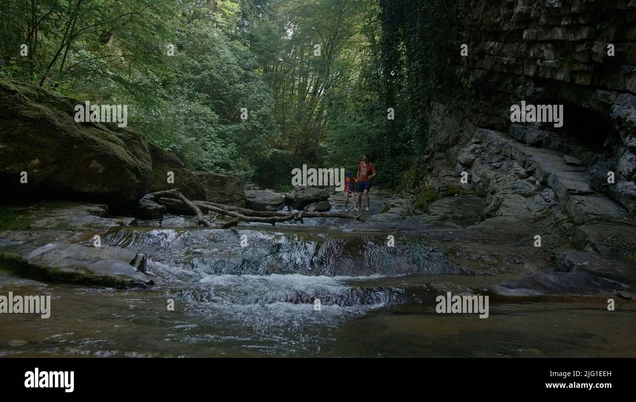 Dad and daughter in the tropics.Creative. A family walking through the ...