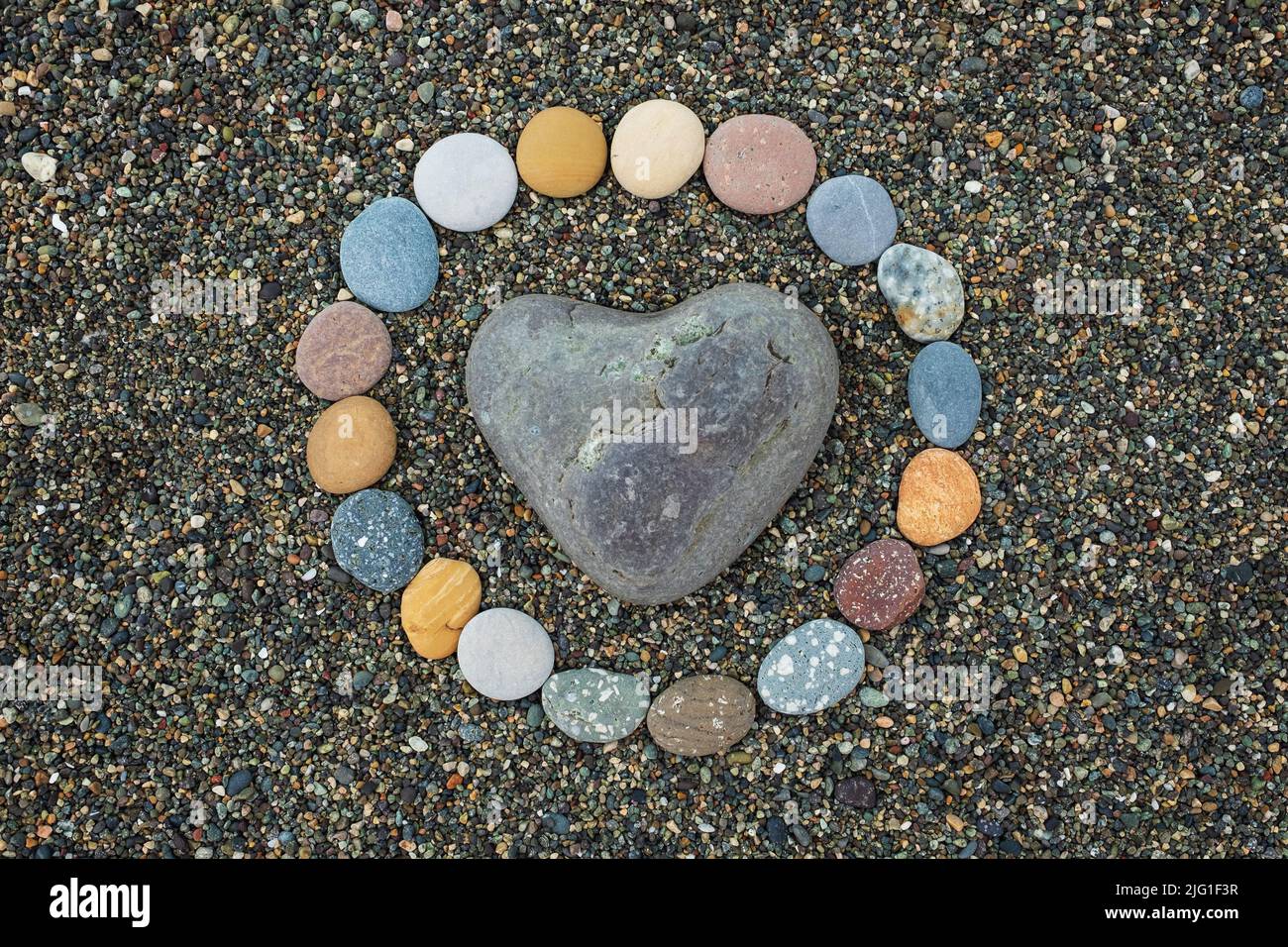 Heart shaped sea stone pebble on sandy beach Stock Photo - Alamy